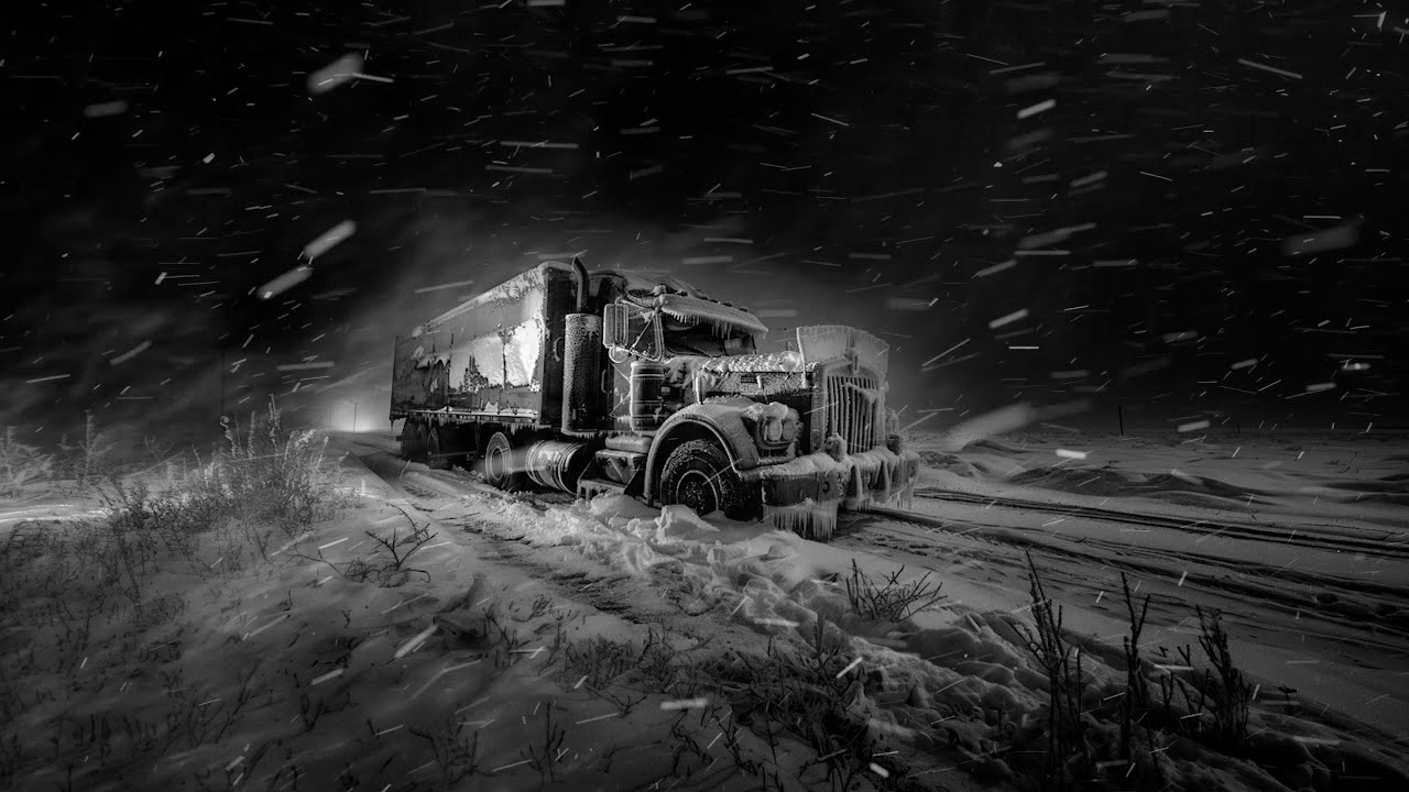 A semi truck driving through the dark snowy woods at night - Strong ...