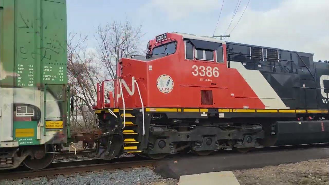 CN 8883, 3386 Eastbound train with high-cube box cars, hoppers, WC gondola at Vicksburg, MI ...