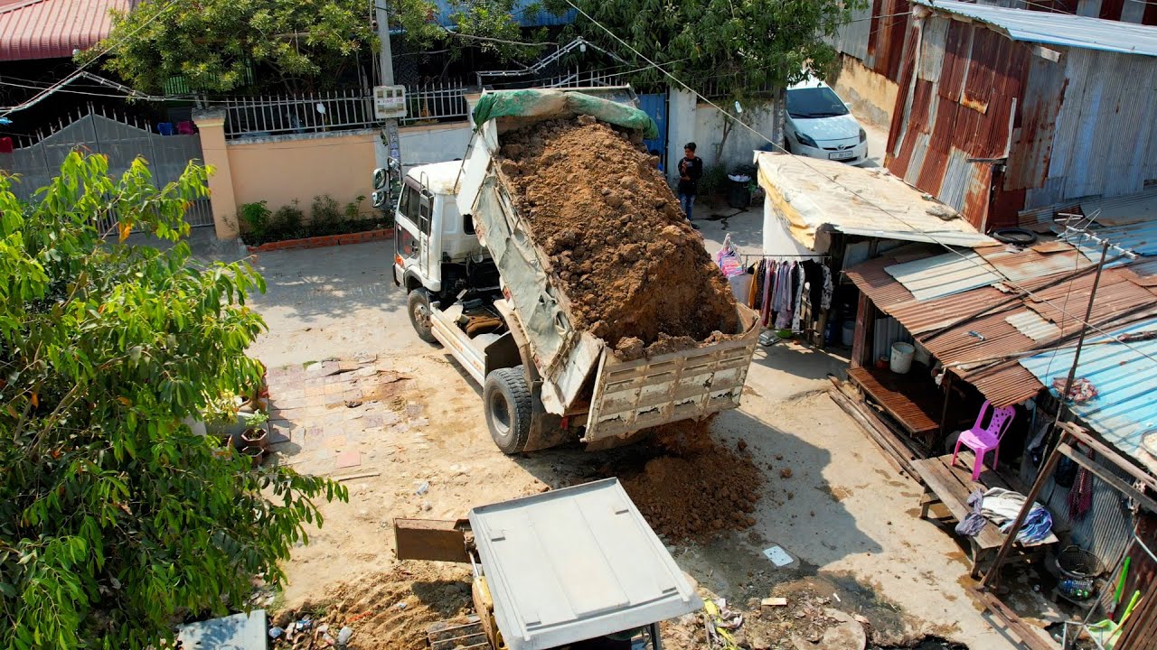 Dump truck working unloading dirt and bulldozer pushing dirt filling 5 ...