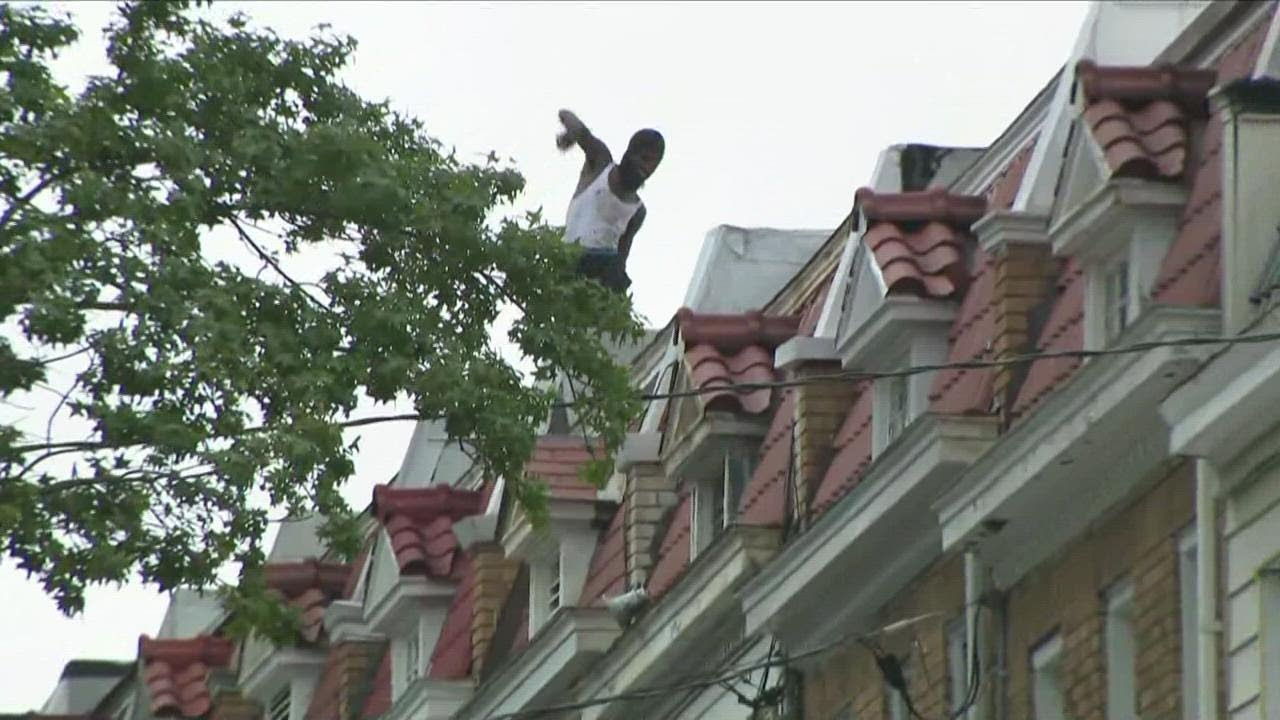 Police attempt to talk down "person in crisis" on the roof, after ...
