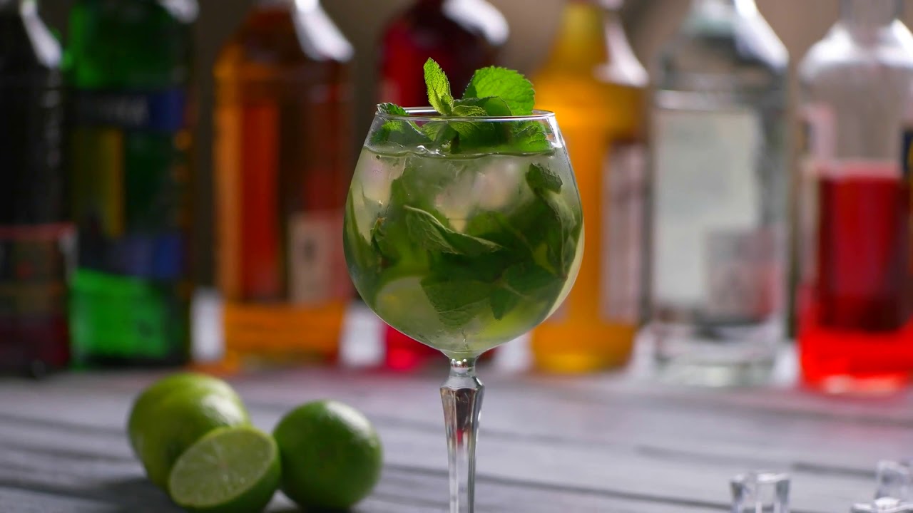 mint branch and green cocktail hand puts mint into beverage fresh mint ...
