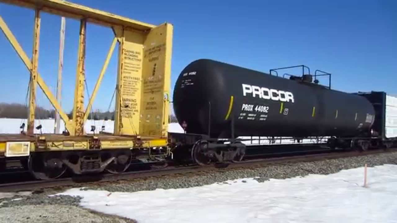 Westbound CN train slows down. ATSF, BN covered hoppers. CN box cars ...