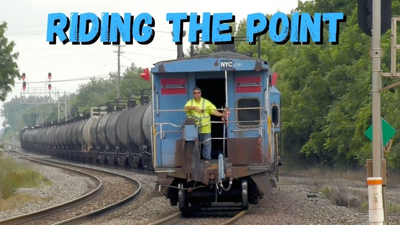 Local train conductor rides the point on an old Conrail caboose as they ...