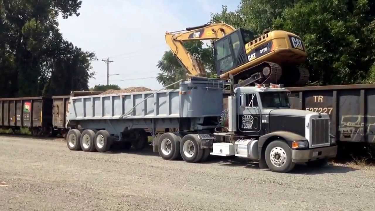Track hoe on rail car unloading rock- Please subscribe to my channel ...