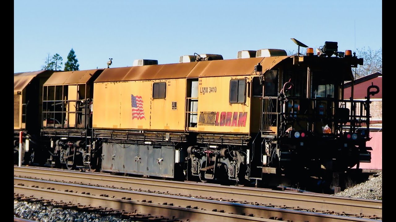 UNION PACIFIC LORAM track machine being serviced by its crew for its ...