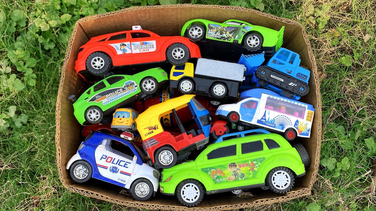 Toy Box full of colourful Police Car, CNG Autorickshaw, Bulldozer ...