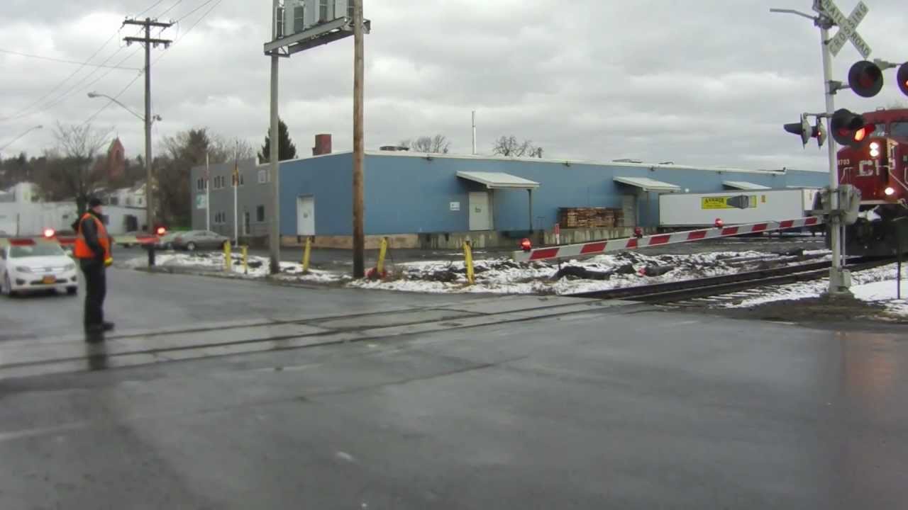 Conductor flags rail crossing (CP 642) - YouTube