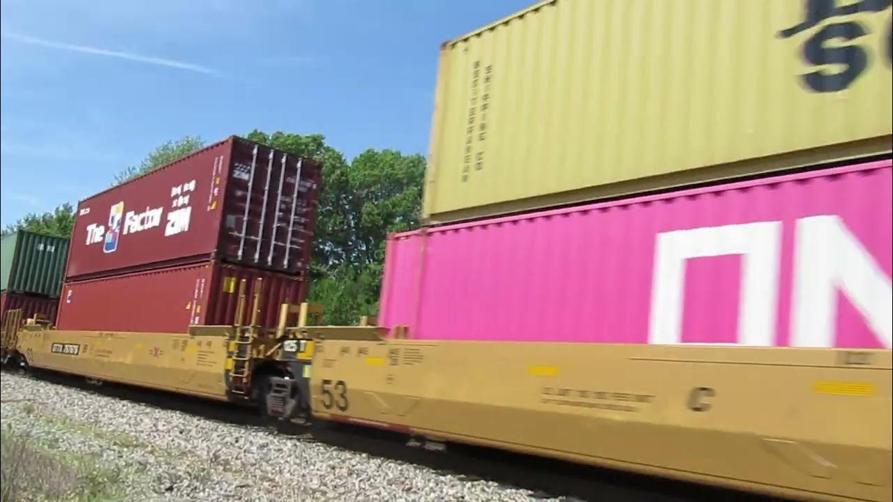 CN 2673, 2603 move a Westbound intermodal shipping container in well car train at Vicksburg, MI ...