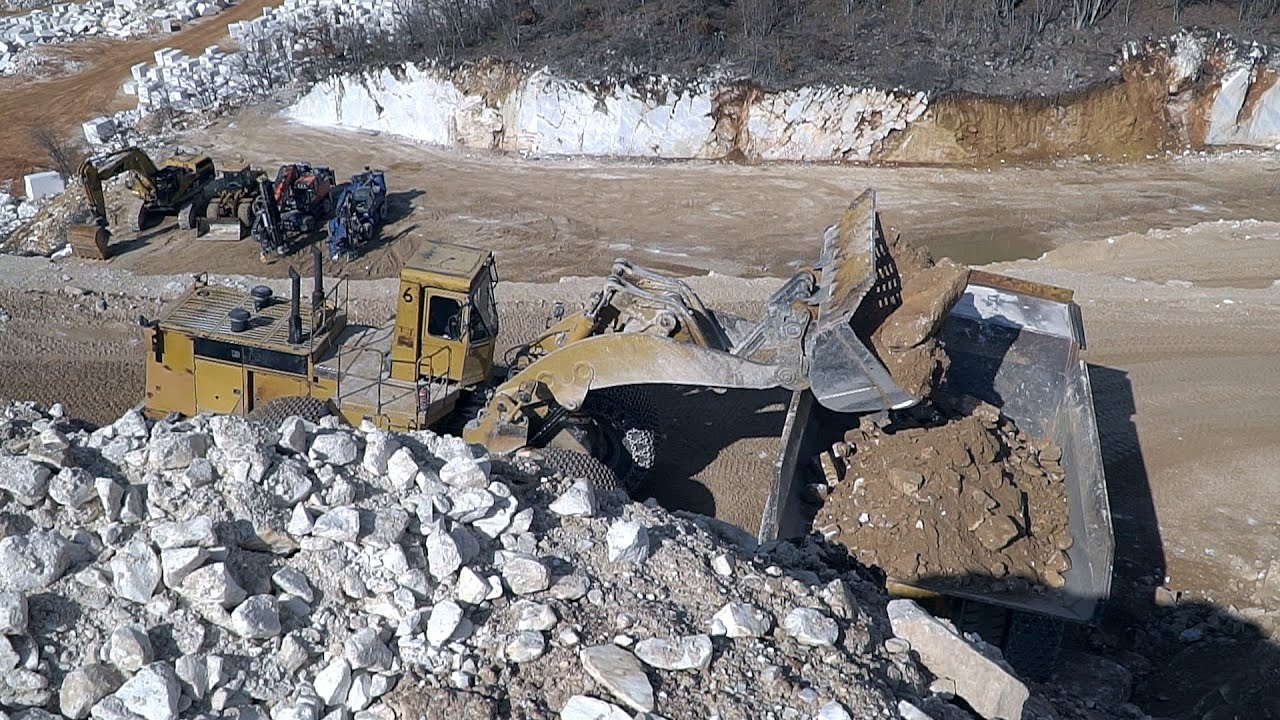 CAT 992 Earthmover Loads Dump Truck in Marble Quarry - YouTube