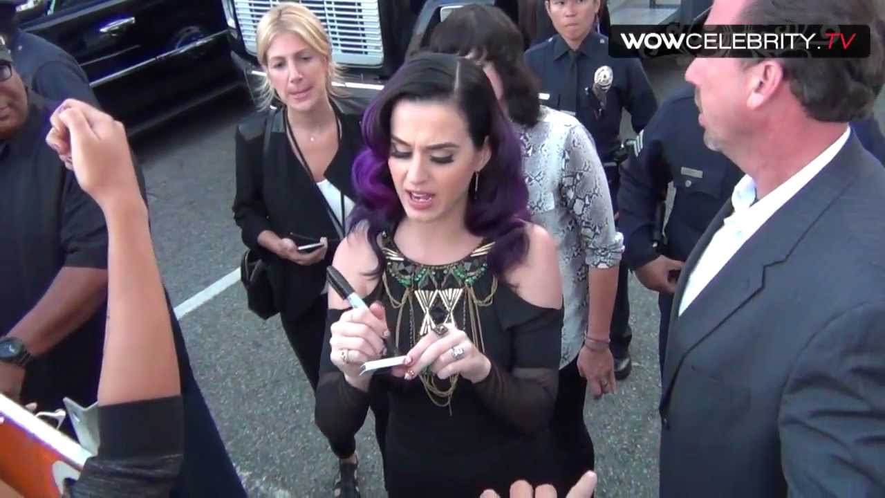 Katy Perry with purple hair signs autographs at Part Of Me film ...