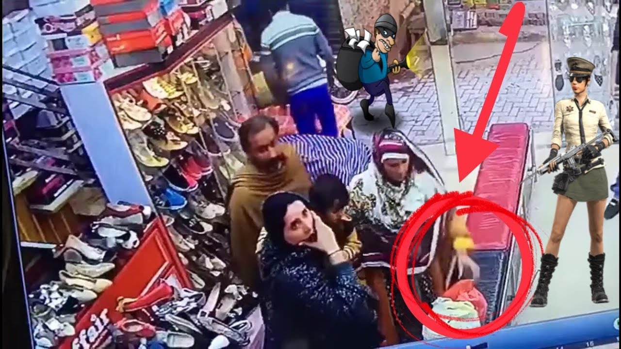 woman stealing in shop / thief in shop / thief caught red handed CCTV ...