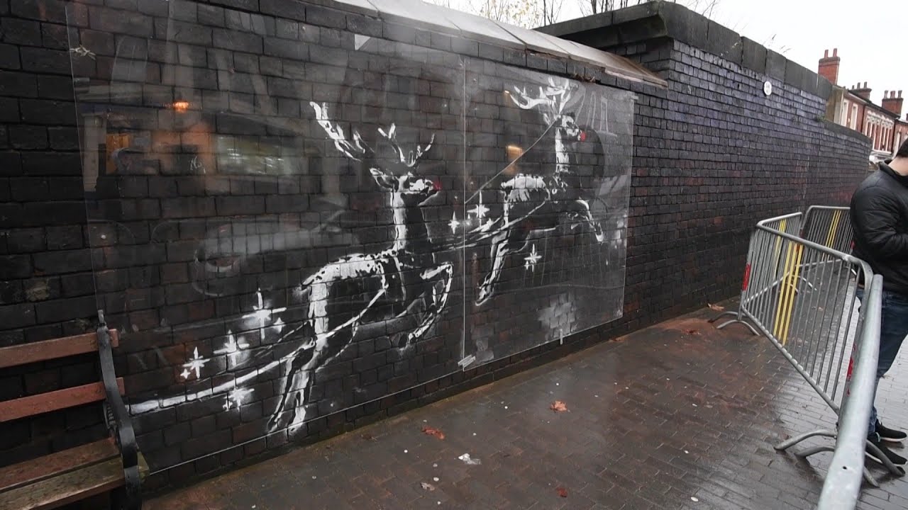 Banksy reindeer mural covered after red noses added | AFP - YouTube