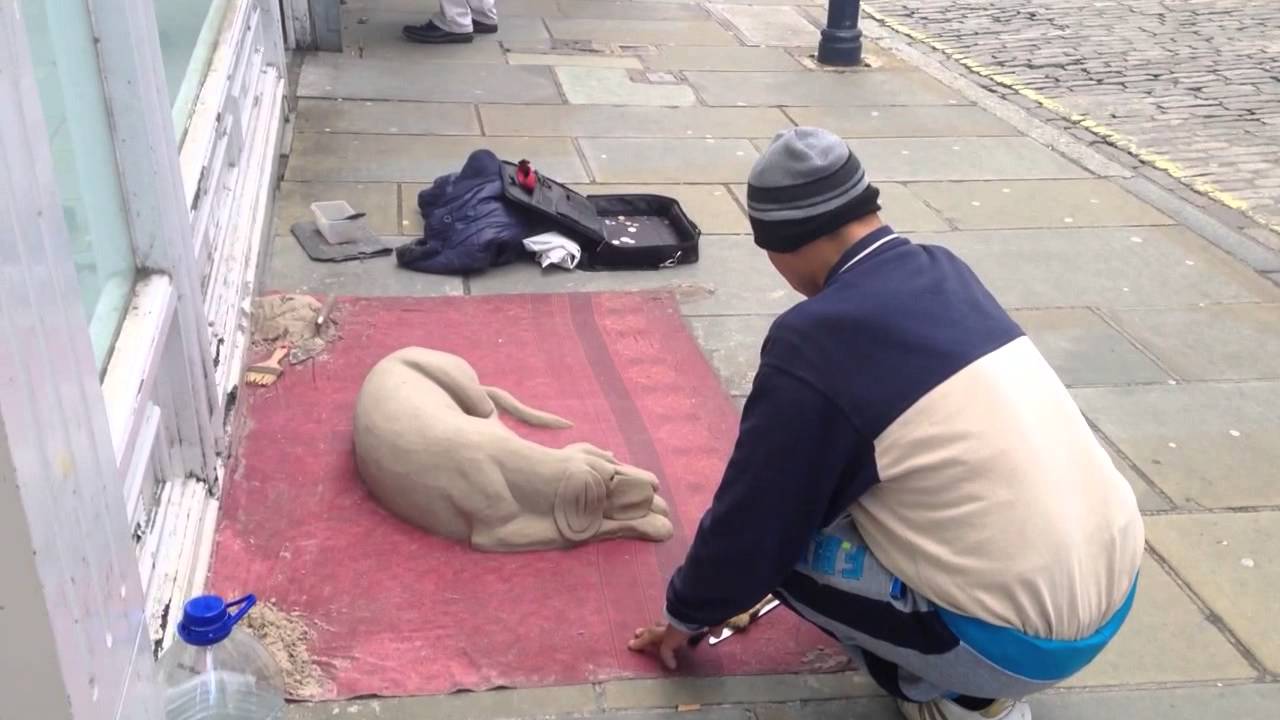 Scam Man Sand dog carving fake? - YouTube
