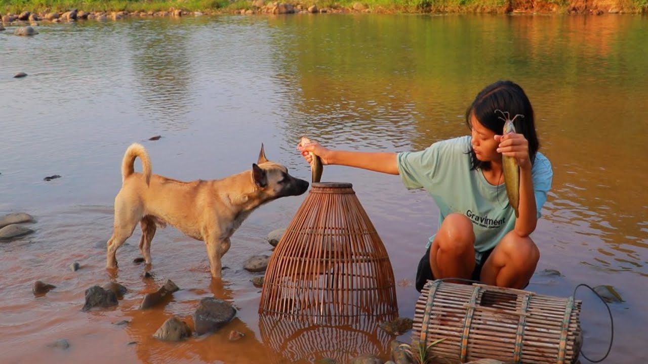 Girl fishing by trap with dog in river - YouTube