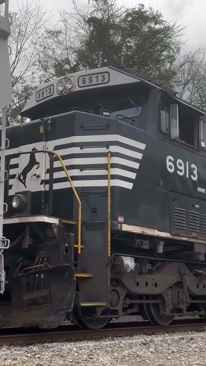 NS 6913 gives a horn salute & a wave as it leads a local train west on the cedartown district ...