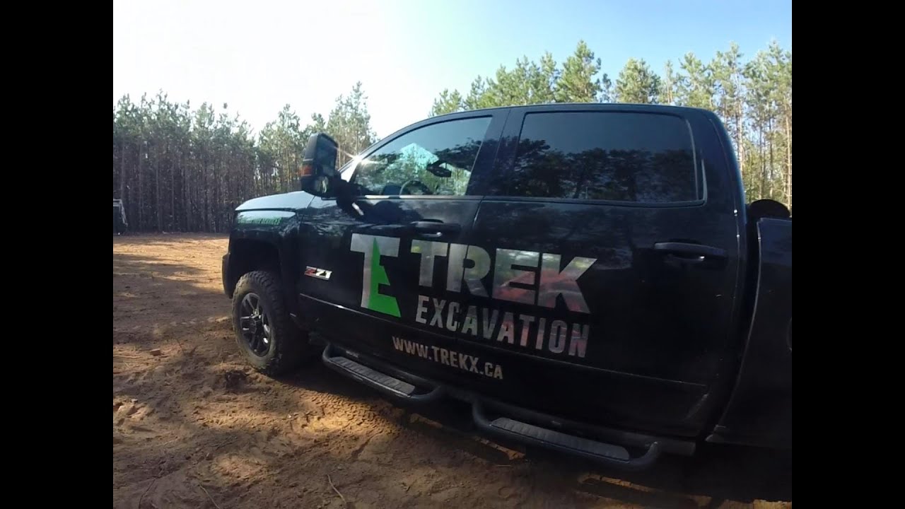 Using a landscape rake and the front end loader on a John Deere 110 ...