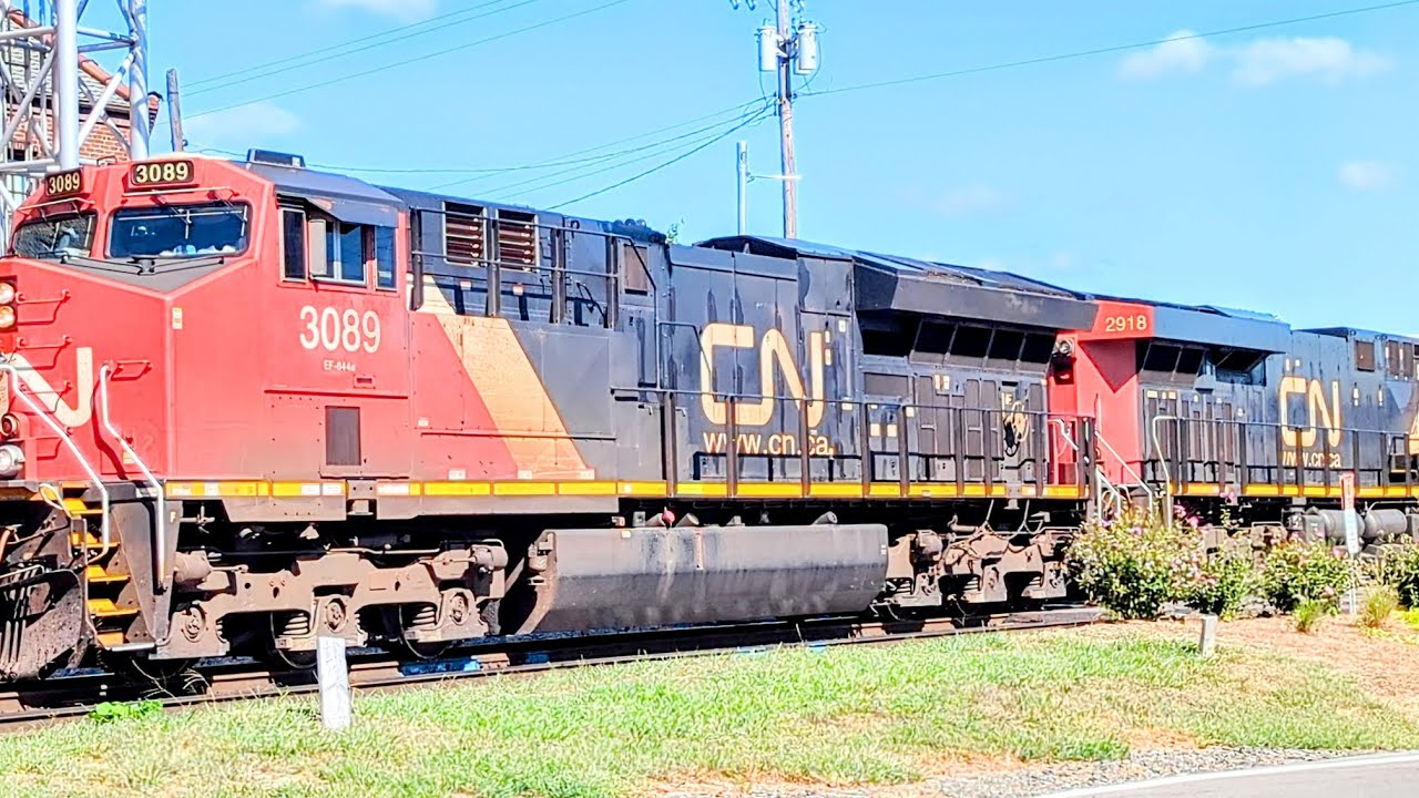 All Canadian National lash up incl mid-train DPU on CSX B241 heading railroad West (S) at Benson ...