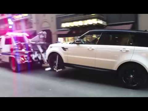 NYPD Traffic Cop's tow the BUDWEISER 18 wheeler plus a Land Rover and a Bentley