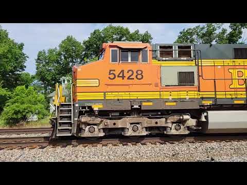 BNSF 5428, CN 3000, 3266 run a Westbound train with logs on bulkhead flat cars past Vicksburg ...